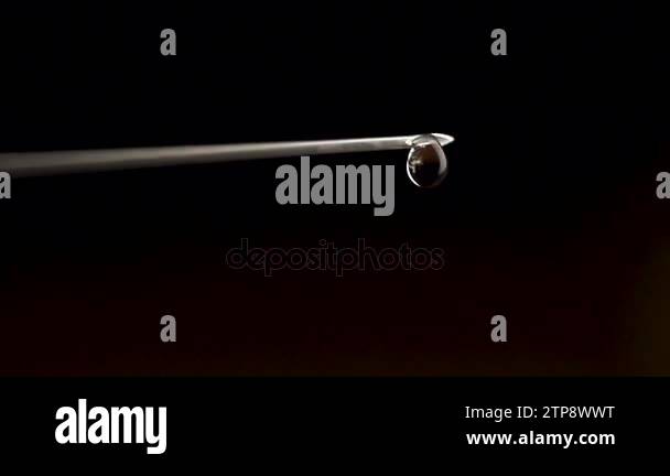 Medical injection syringe with drop falling from the needle shallow ...