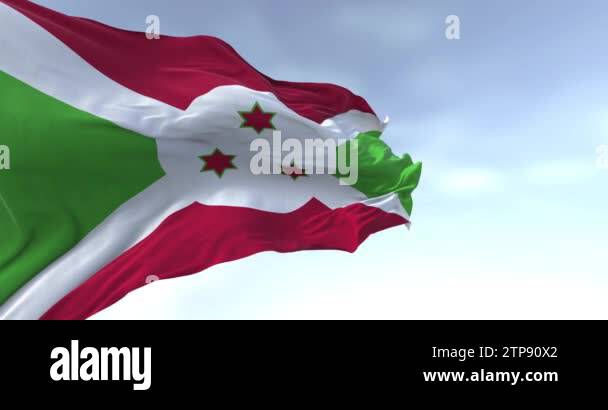 Burundi national flag waving on a clear day. White diagonal cross ...