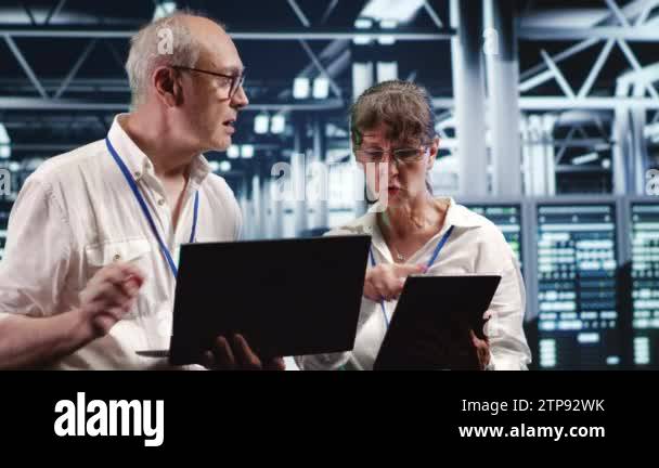 Professionals monitoring energy efficient data center equipment. Server components using ...