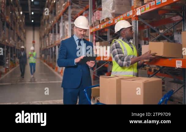 Male supervisor of logistics enterprise managing work process. Foreman ...