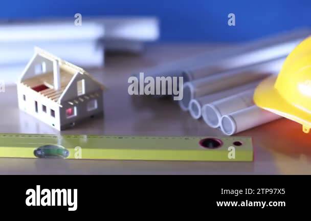 Real-estate development and development planning. House under construction, blueprints and ...