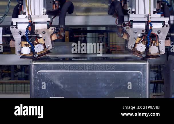 A steel box turns inside a robotic machine during welding process. 4K ...
