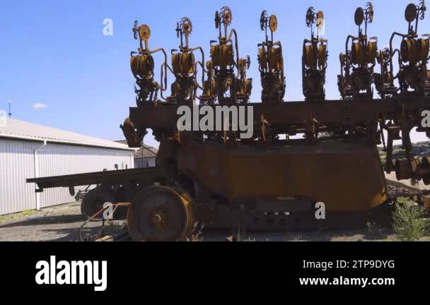 Damaged agricultural machinery destroyed by artillery fire (panorama ...
