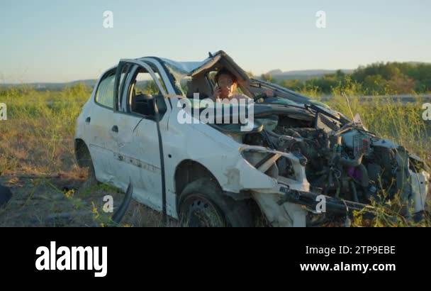 The driver of the wrecked car is in shock after the accident. Destroyed ...