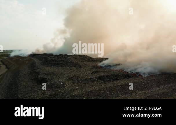 Aerial view of an environmental disaster fire at a large plastic waste ...