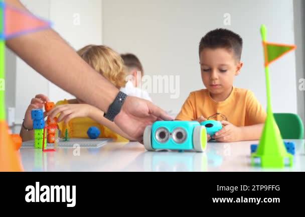 Children playing with toy car control panel in STEM educational class ...
