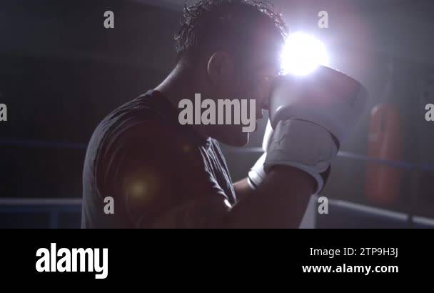 Two fighters battling each other inside ring in speed-ramp slow-motion ...