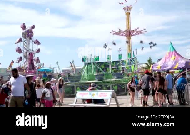 People riding on spinning swing carousel in amusement park Swing rides ...