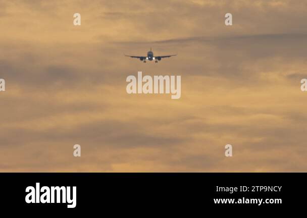Jet Plane Approaching To Land Descending In The Sunset Sky Footage Of