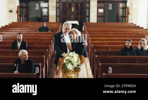 Funeral, church and couple hug by coffin for goodbye, mourning and ...