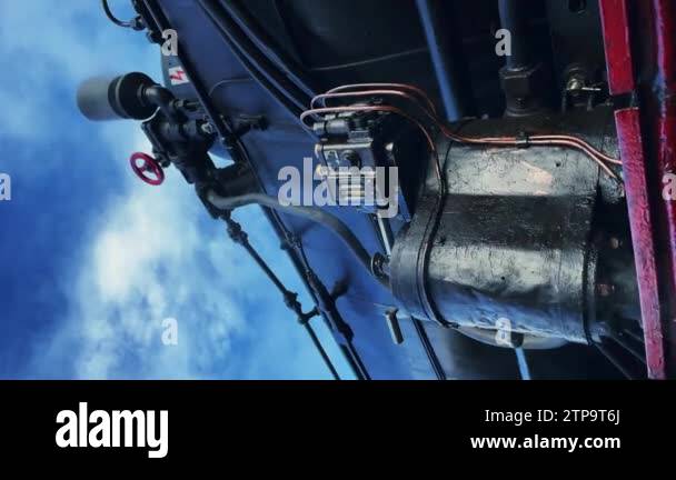 Close up of working mechanisms of coal steam locomotive at railroad ...