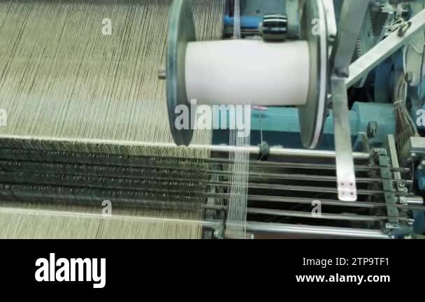 Weaving loom at a textile factory. close-up. working process. big spool ...