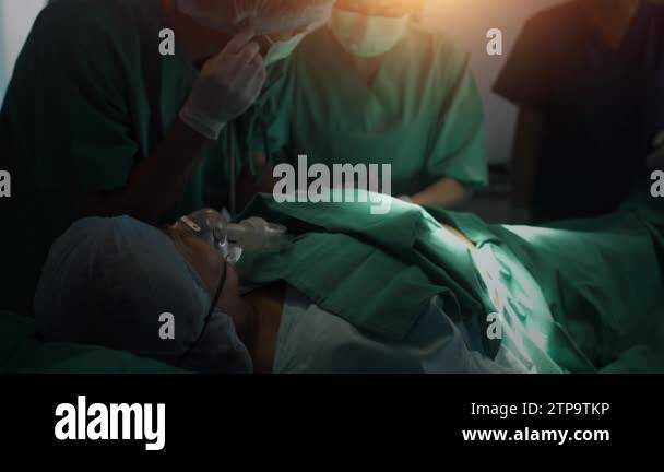 A surgeon diagnosing and identifying an elderly woman's heart problem ...