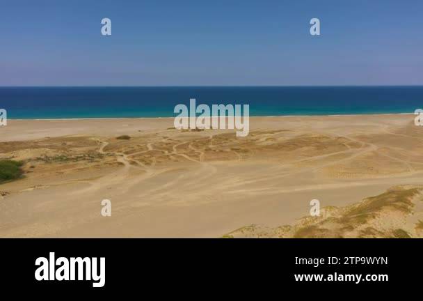 Sandy beach and blue ocean. Paoay Sand Dunes, Ilocos Norte, Philippines ...