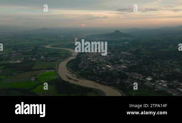 Valencia City with winding river, farmland, and houses. Mt. Kalayo in ...