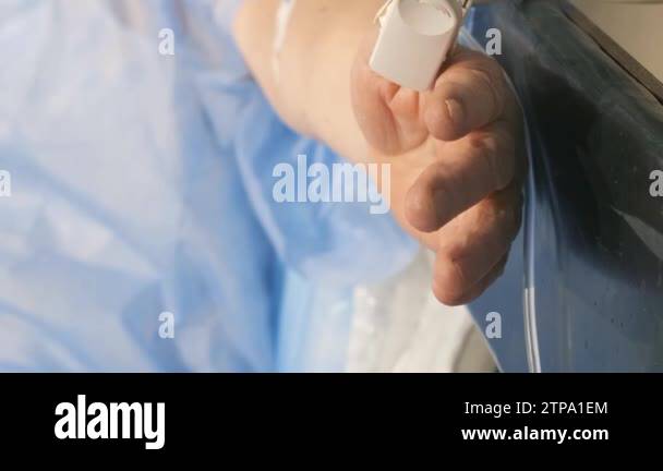 An elderly woman, a grandmother, is on the operating table, having a ...