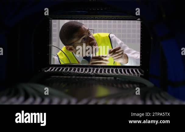 Computer technician checking the equipment in a data center server room ...