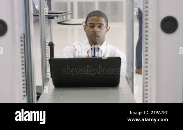 Technical engineer carrying out checking in a data center server room ...