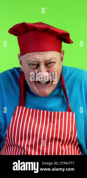 Senior cook in apron hysterically laughing over funny joke. Mature chef ...
