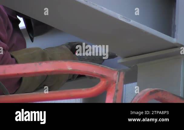 Industrial welder welding metal structure in the construction of a ...