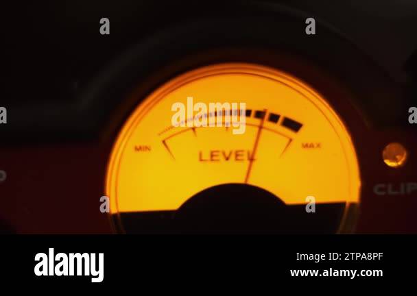 Analog dial indicator of audio signal level. Vintage arrow moves in ...