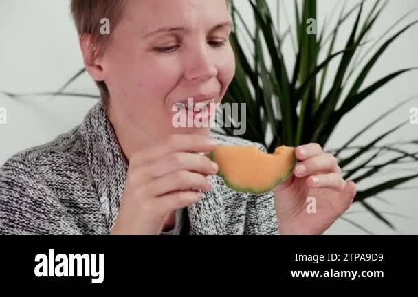 A middle-aged woman eats a melon. Proper nutrition, eating fruits ...