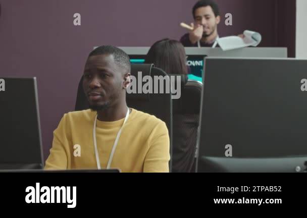 Waist up shot of thoughtful young African American male programmer ...