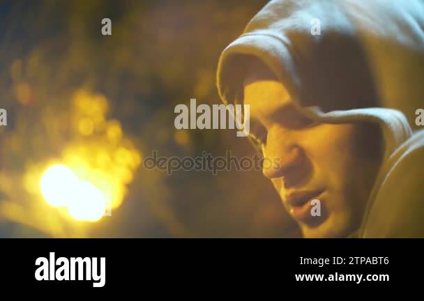 Profile of a sad man with a hood. close-up, background blur, bokeh. 4k ...