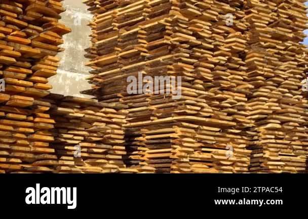 Piles of wooden boards in the sawmill. Production of wooden boards ...