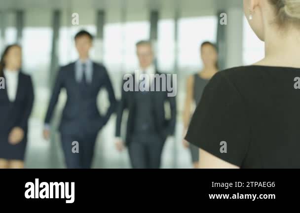 4K Business teams meet and shake hands in large modern office building ...