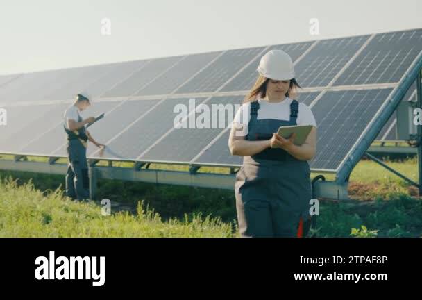 Workers in overalls at the production of alternative electricity ...