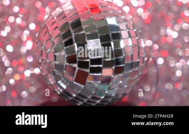 Disco ball filmed in the studio with a silver background and movement ...