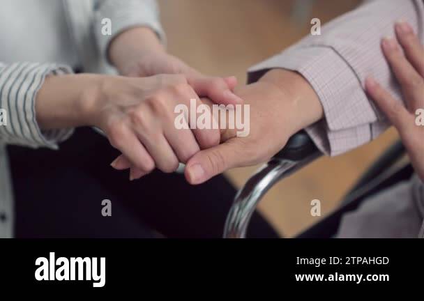 Close up of hand of unrecognizable woman supporting her mother with ...
