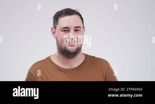 Man, secret and finger on mouth by smile, mystery and silence in studio ...