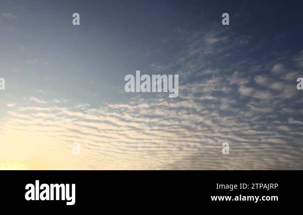 White clouds disappear in the hot sun on blue sky. Time-lapse motion ...