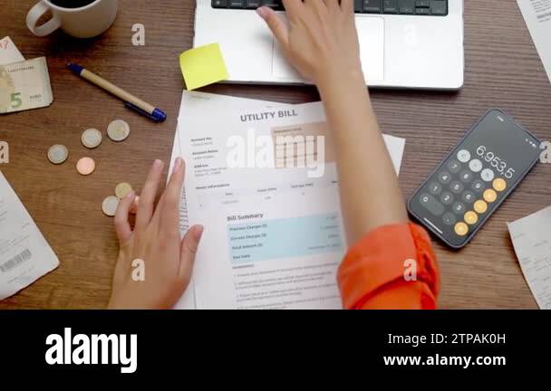 Businesswoman counts coins and banknotes sitting at table with bank ...