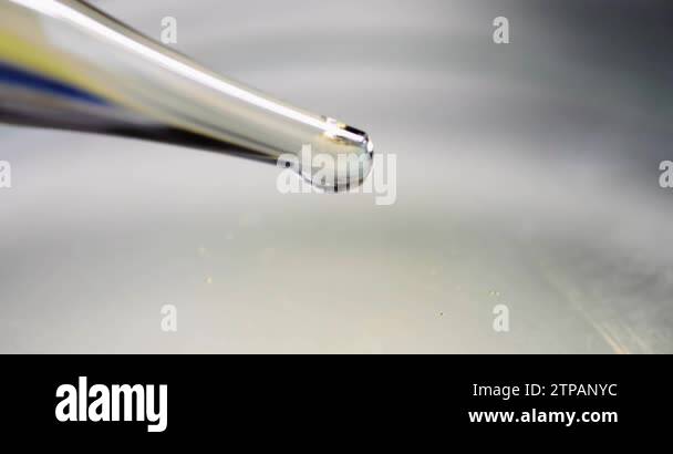 Drop falling from glass pipette in laboratory closeup 4k movie slow ...