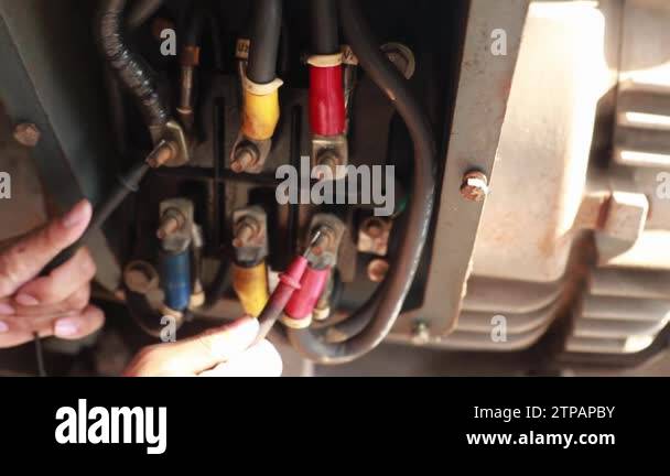 Stop checking the motor repairs : Closeup male electrician worker uses ...