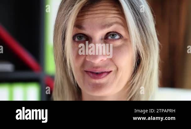 A smiling woman rolls her eyes, a close-up face. Facial expressions and ...