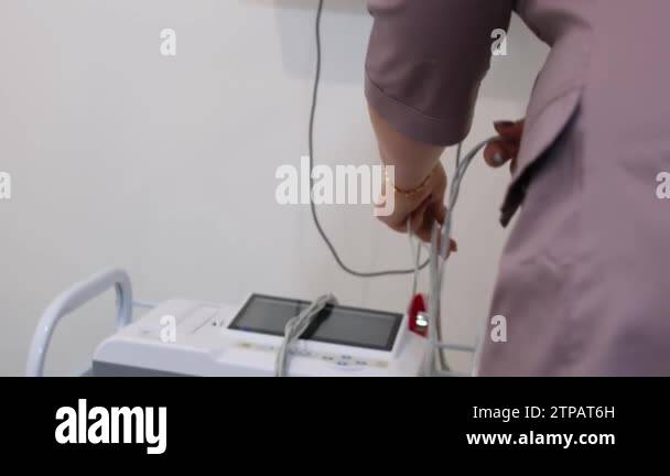 cardiogram in the hospital woman doctor examines a man patient puts ...