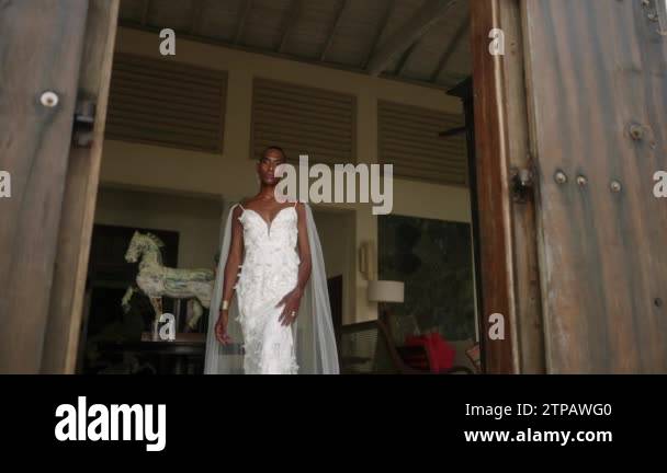 Elegant androgynous person of color walks model gait around villa and ...