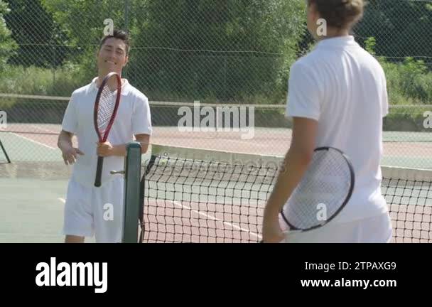 4K Male tennis players taking a break from game to get his breath back ...