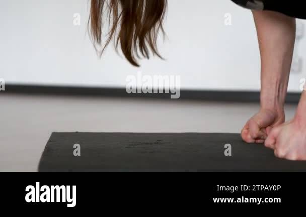 Close-up of a girl doing push-ups and smoothly goes on her hands ...