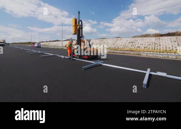 ALMATY, KAZAKHSTAN - AUGUST 16 2023: Builders install median fence ...