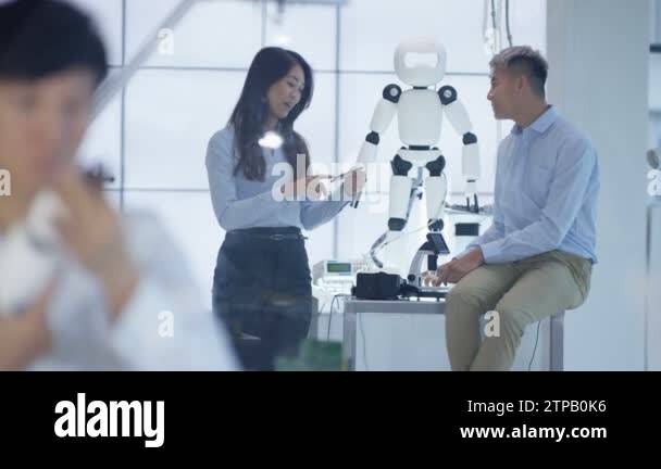 4K Technical design team working on construction of robot in modern lab ...