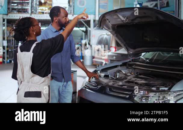 Engineer in auto repair shop using augmented reality technology to ...