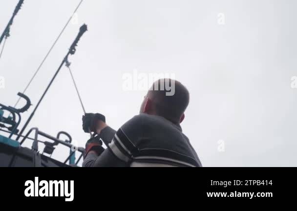 Bottom view of professional driver stands at back side of trolleybus ...
