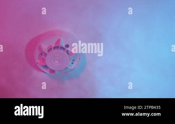 The smoke detector is mounted on the ceiling and the smoke rising ...