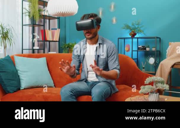 Indian man using virtual reality futuristic technology VR app headset ...