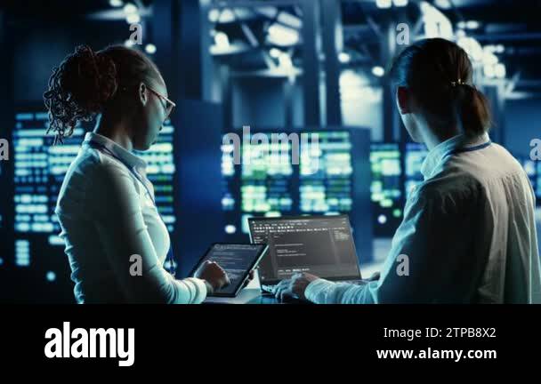 Coworkers programming in server hub housing advanced infrastructure storing massive datasets ...